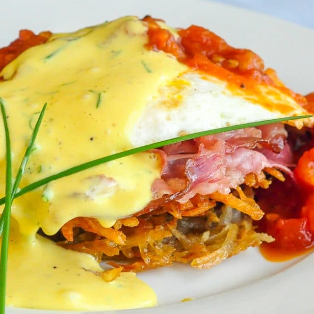 Tomato Eggs Benedict with Potato Latkes and Prosciutto